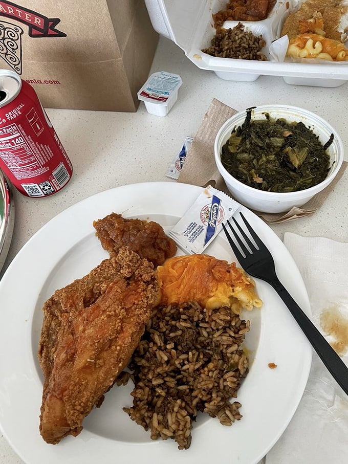A plate that proves heaven exists on earth: crispy chicken, dirty rice, mac and cheese, and collard greens that taste like someone's grandmother made them.