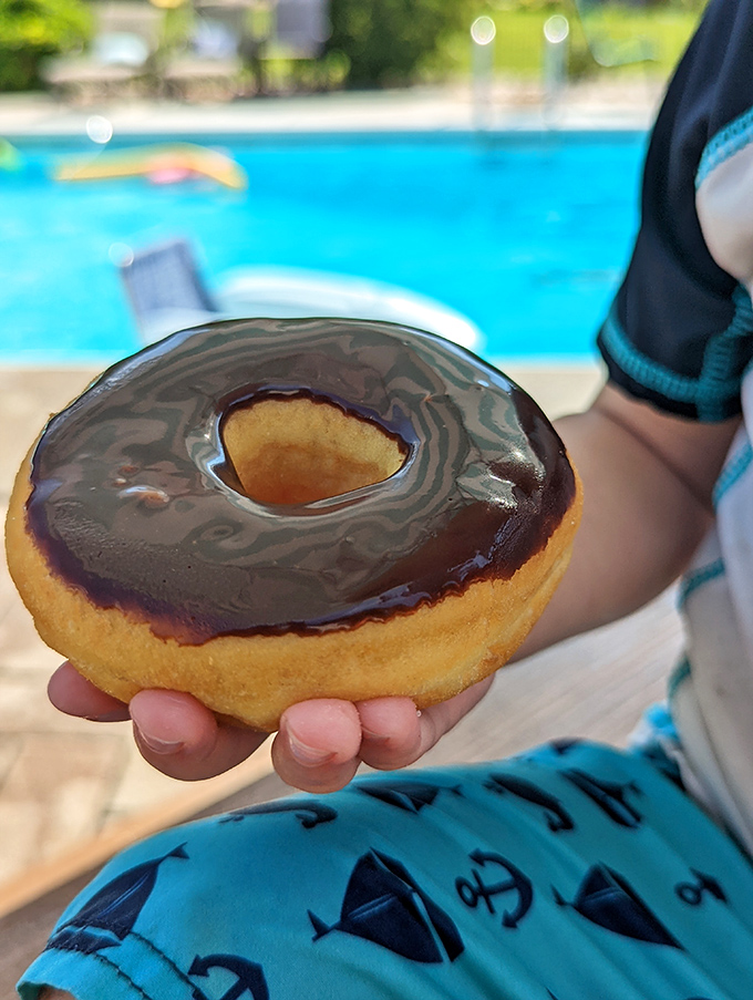 Poolside donuts&mdash;proving that "balanced breakfast" can mean "chocolate frosting perfectly balanced on pillowy fried dough."