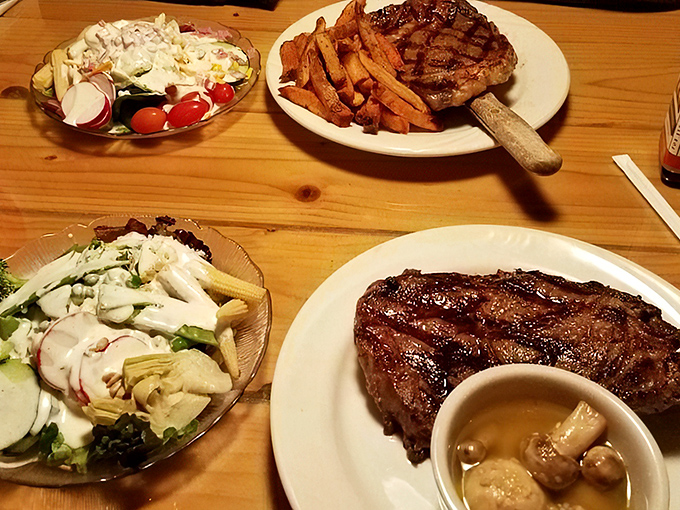 Two steaks, two salads, and the unspoken promise that you'll be thinking about this meal during your next disappointing restaurant experience elsewhere.