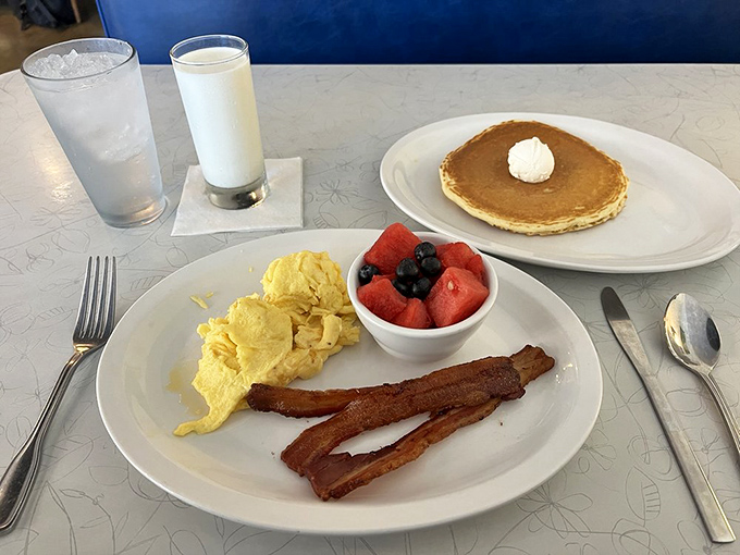 Simple perfection on a plate. Those golden scrambled eggs and bacon strips are the breakfast equivalent of a perfect melody&mdash;no autotune needed.
