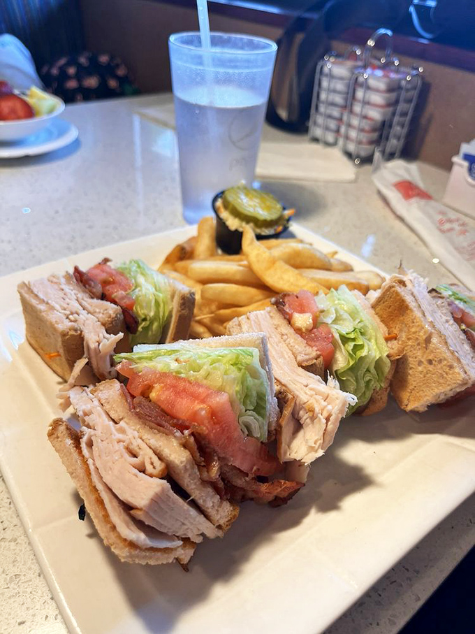 A club sandwich that's stacked higher than my unread emails, with layers that work together better than most office teams.