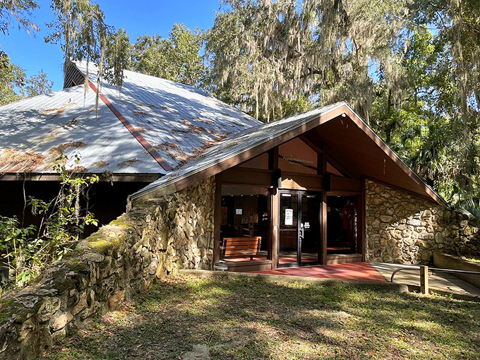 The visitor center blends into its surroundings like it grew from the earth itself—rustic stone and timber welcoming explorers since the 1970s.