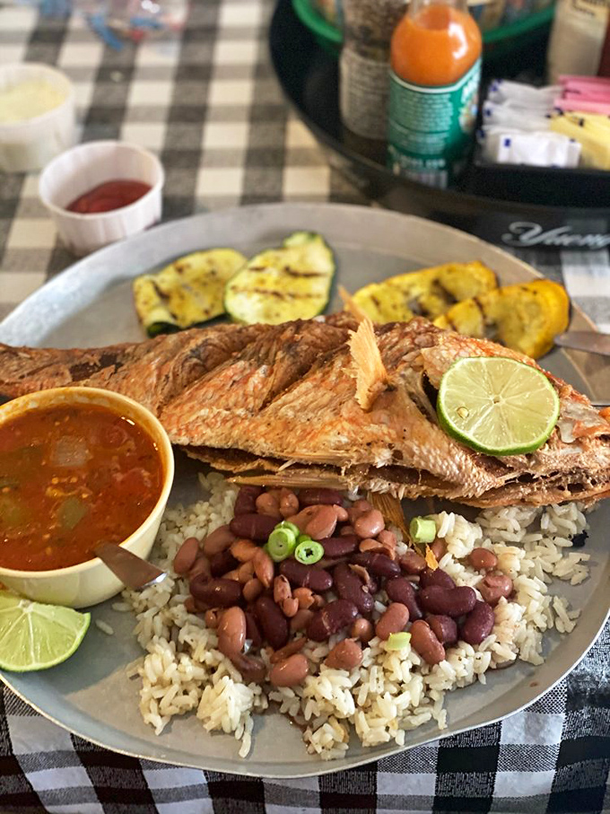 A whole fish that stares back with pride. This red snapper rests on rice and beans like royalty on a throne of flavor.