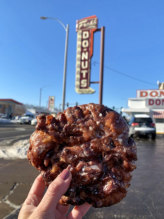Holding an apple fritter against the iconic sign&mdash;a Missouri moment that belongs on the cover of "Roadside Americana Monthly."