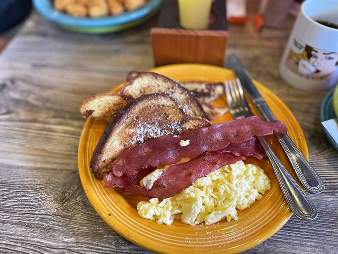 Simple pleasures executed perfectly: golden-brown toast, crispy bacon, and scrambled eggs sharing a fiesta plate&mdash;the breakfast equivalent of a greatest hits album.