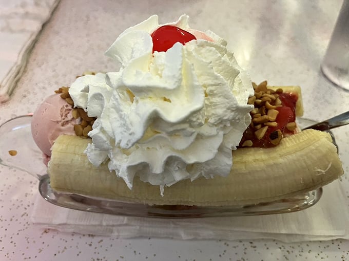 This banana split isn't dessert&mdash;it's performance art with whipped cream, a reminder that sometimes happiness is just frozen dairy with strategic fruit placement.