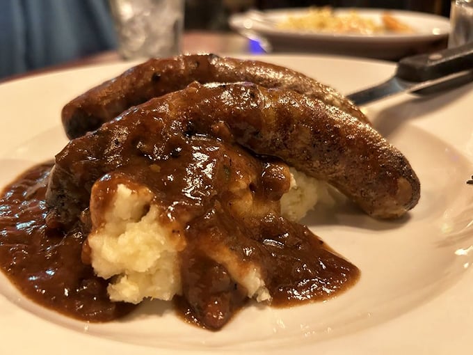 Bangers and mash with gravy so rich it could buy a small island&mdash;comfort food that hugs you from the inside out.
