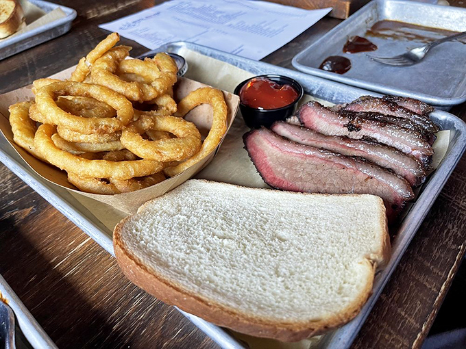 The perfect barbecue equation: smoke-kissed brisket + golden onion rings + white bread = a Texas-inspired trifecta that solves all of life's problems.