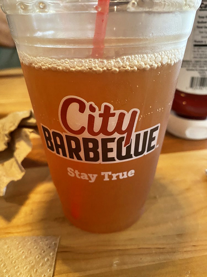 That amber glow isn't just beer—it's liquid sunshine with a side of "Stay True." Words to live by when it comes to proper BBQ.