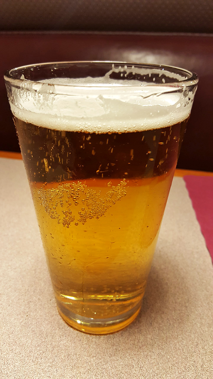 Even the beer arrives with perfect layering, like a sunset in a glass after a long day of adulting.