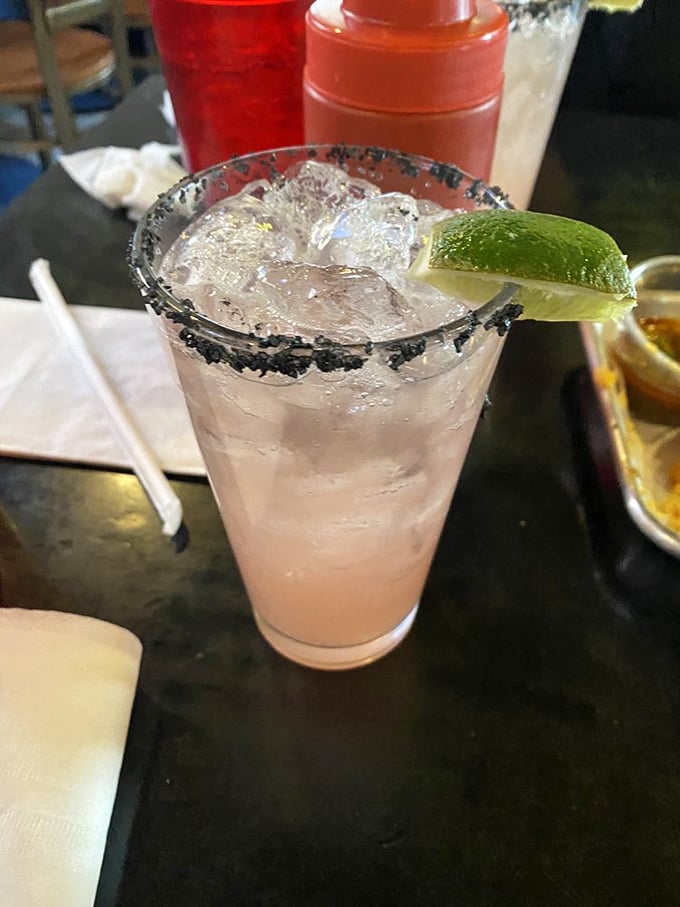 A salt-rimmed cocktail stands ready to cut through the richness of your burger adventure. Hydration is not just recommended&mdash;it's tactical.