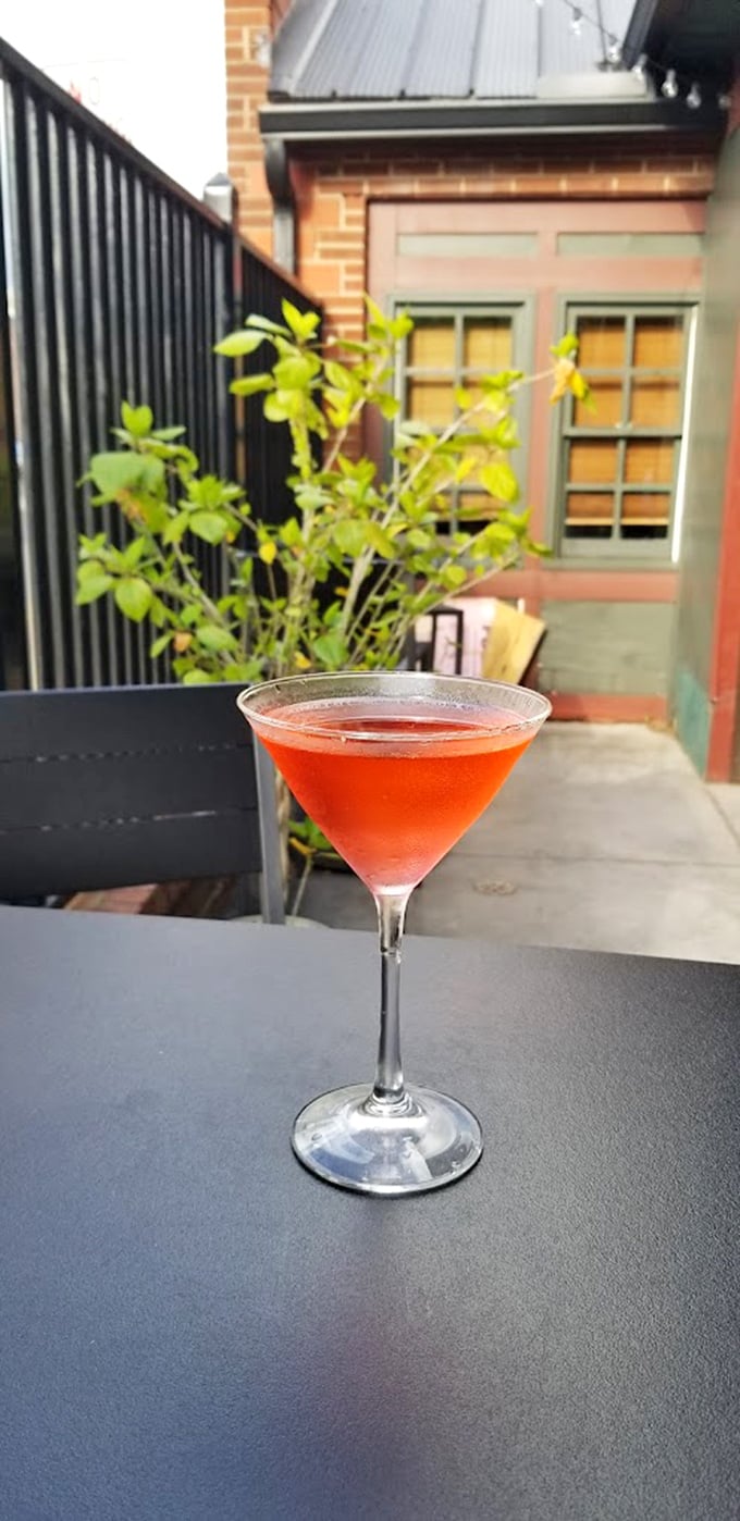 A ruby-red cocktail catching the afternoon light &ndash; liquid proof that happy hour at Olde Jaol is taken as seriously as dinner.
