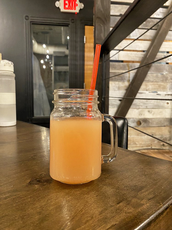 This isn't just a beverage—it's liquid sunshine in a mason jar mug, served against a backdrop that screams "Instagram me now!"