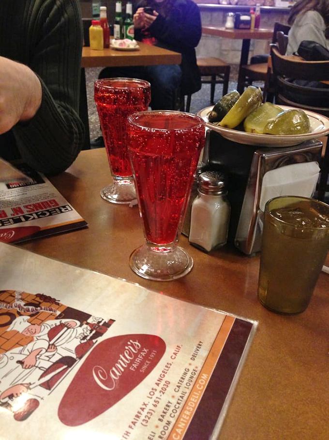 Those crimson sodas aren't just beverages; they're time machines in glassware. One sip of Dr. Brown's and suddenly you're in your grandparents' kitchen, arguing about politics over pickles.