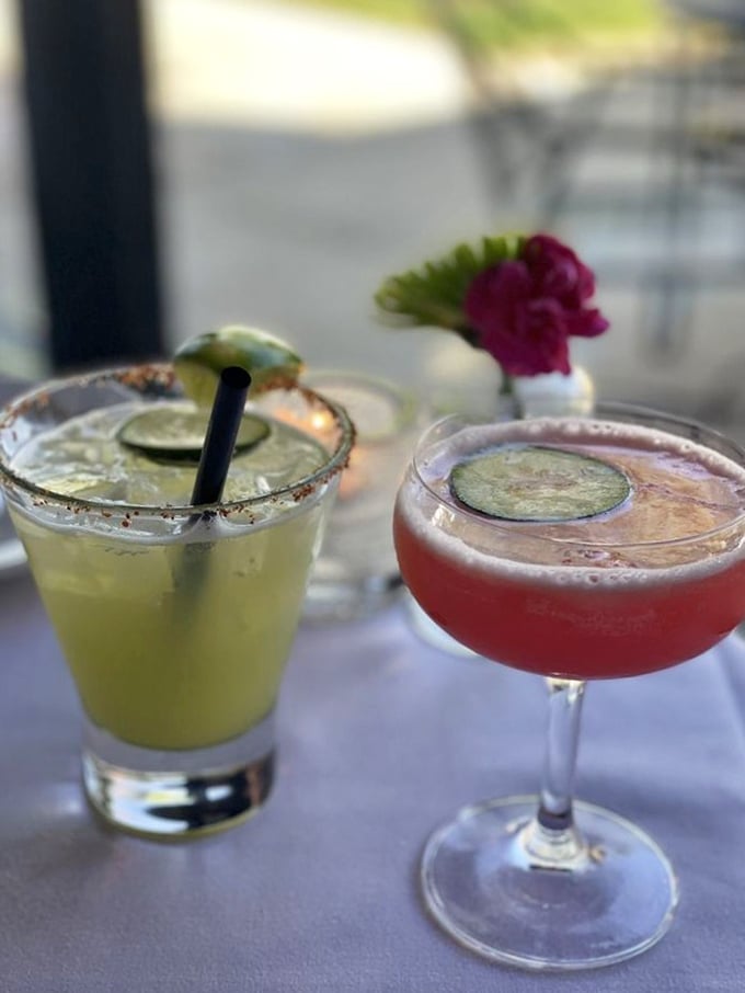 Cocktails that look like liquid sunshine. The pink drink whispers "sophisticated" while the green one shouts "vacation"&mdash;both promise a good time.
