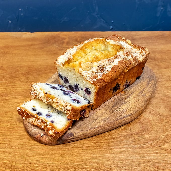 This blueberry loaf is what happens when fruit and cake have a beautiful romance—each slice revealing purple jewels suspended in buttery perfection.
