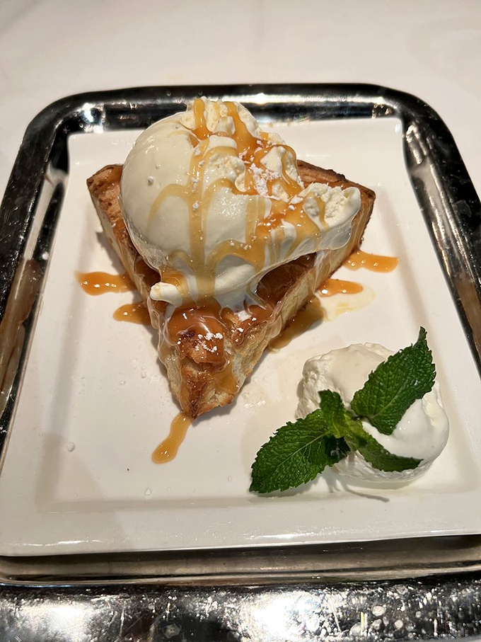 Sweet surrender on a plate. This warm, caramel-drizzled creation with melting ice cream proves dessert stomachs are definitely real.