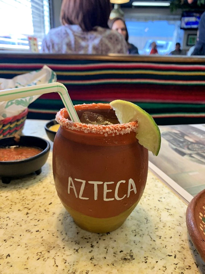 A proper cantarito served in earthenware proudly bearing the Azteca name—proof that sometimes the vessel matters almost as much as what's inside.