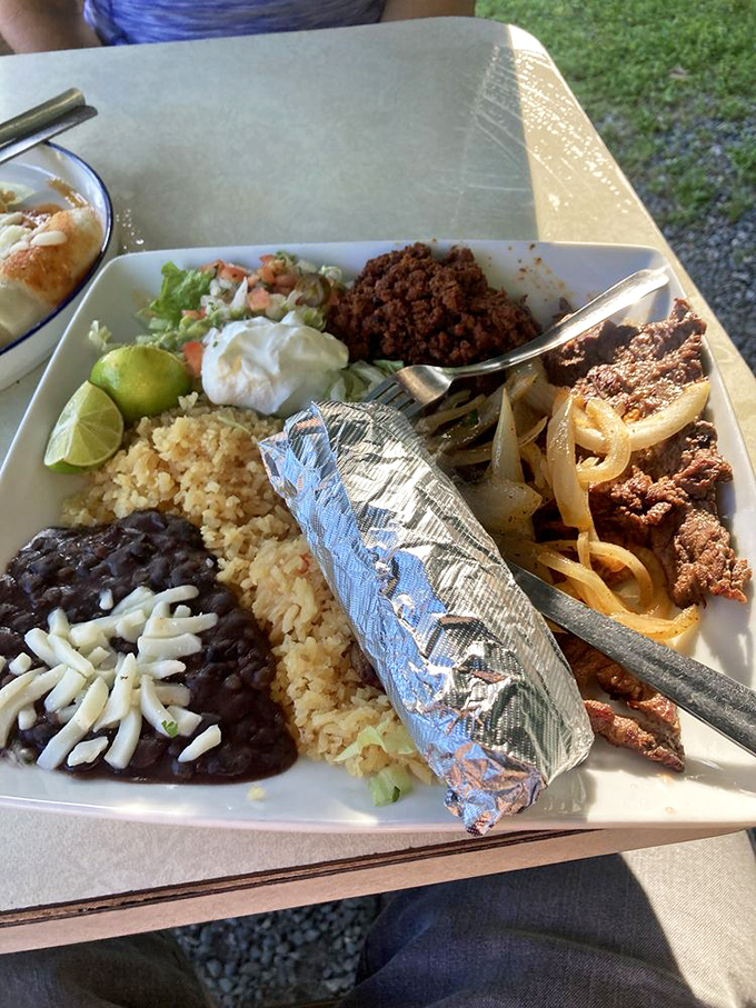 A feast fit for royalty! Rice, beans, tortillas, and all the fixings surround the star of the show&mdash;perfectly grilled carne asada.