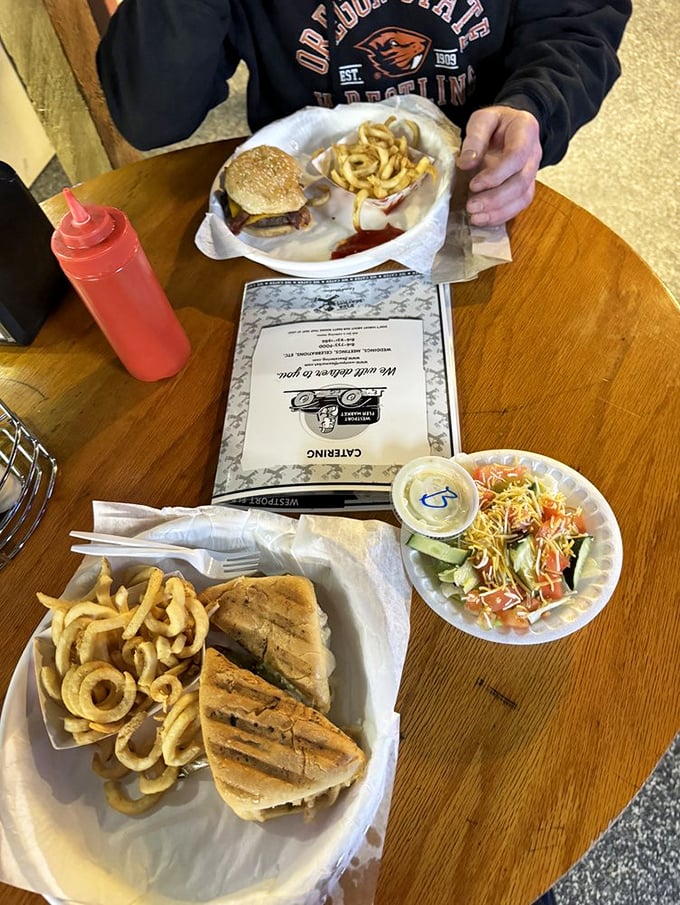 Even the to-go packaging can't contain the glory of this hefty burger and its spiral-cut potato companions.