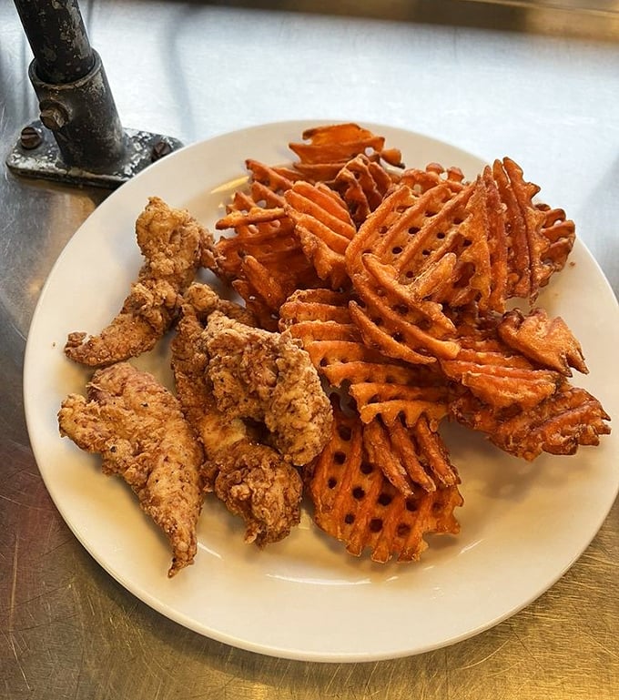 Comfort food royalty: golden chicken tenders with sweet potato waffle fries. The kind of plate that makes you forget all about your diet resolutions.