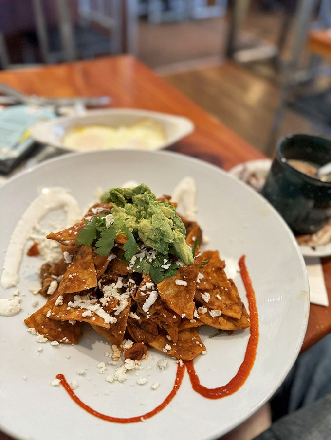 These chilaquiles aren't just breakfast&mdash;they're edible sunshine with a kick. That avocado crown makes it practically a health food, right?