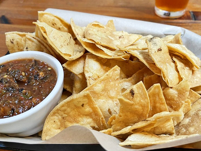 House-made tortilla chips that shatter with satisfying crispness, paired with salsa that dances between sweet, smoky, and spicy notes. 