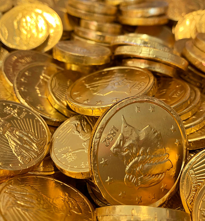 Chocolate coins glimmer like pirate's treasure, proving that while money can't buy happiness, chocolate currency comes impressively close.