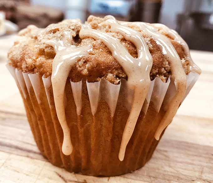 This cinnamon apple crumb muffin wears its drizzled icing like a crown, proving that breakfast pastries can indeed be royalty.namon apple crumb muffins