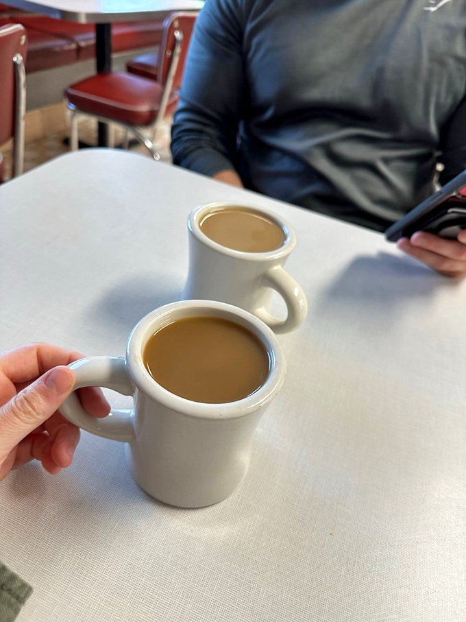 Two mugs of diner coffee&mdash;the fuel that powers America's conversations. In these cups rests liquid ambition and the promise of possibility.