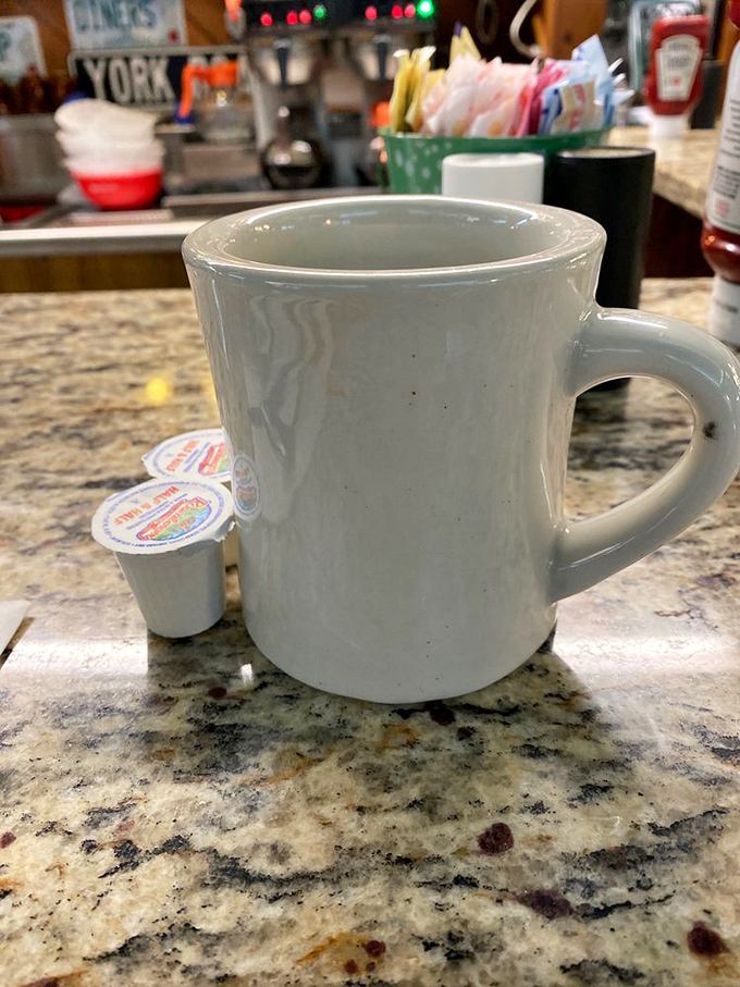 The sturdy white mug&mdash;diner code for "we're serious about coffee." No fancy latte art, just honest brew that keeps coming until you surrender.