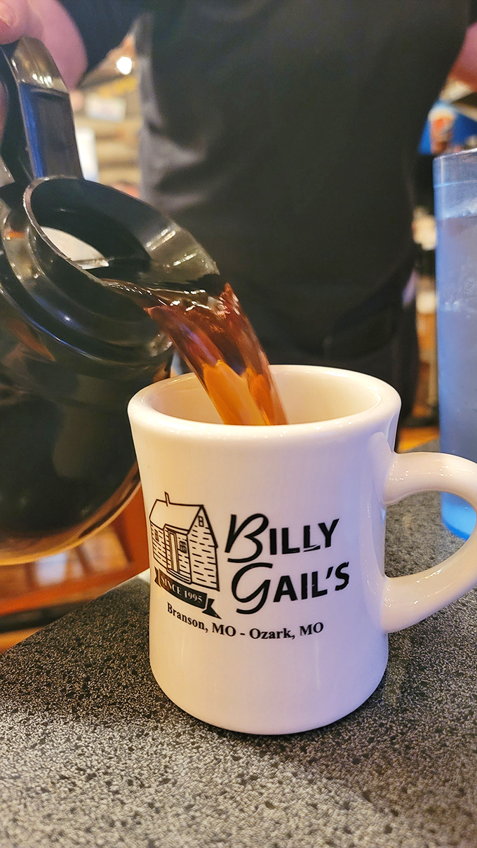 The coffee mug tells a story: "Since 1995," it says, suggesting decades of caffeinated conversations and morning revelations at this Ozark treasure.