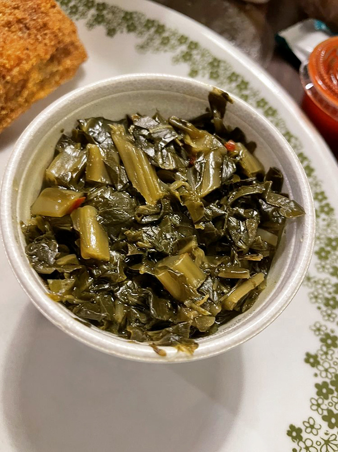 Soul-warming collard greens that cut through the richness of fried seafood like a well-timed punchline in a heartfelt conversation.