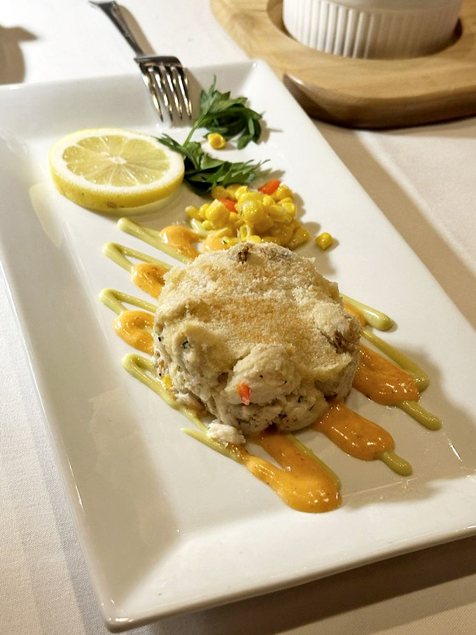 This crab cake contains so much actual crab it's practically a structural miracle. Engineering meets culinary art on a rectangular canvas.