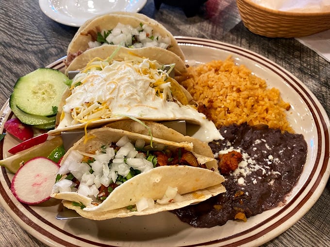 Tacos lined up like eager contestants in a delicious pageant, with Mexican rice and black beans serving as the perfect supporting cast.