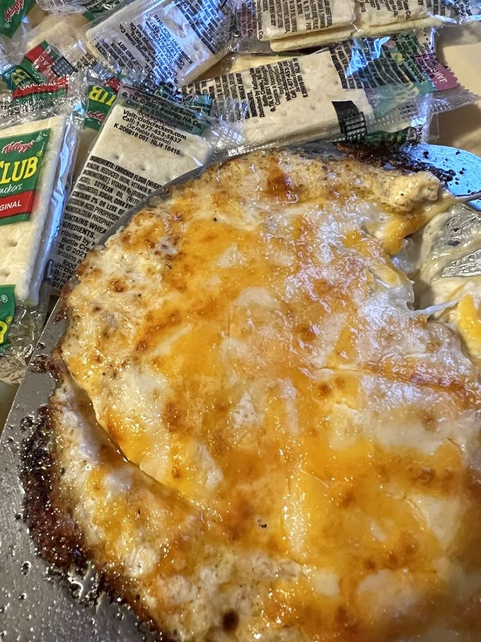 Melted cheese with crackers standing by for dipping duty &ndash; comfort food that makes you wonder why anyone bothers with fancy appetizers.