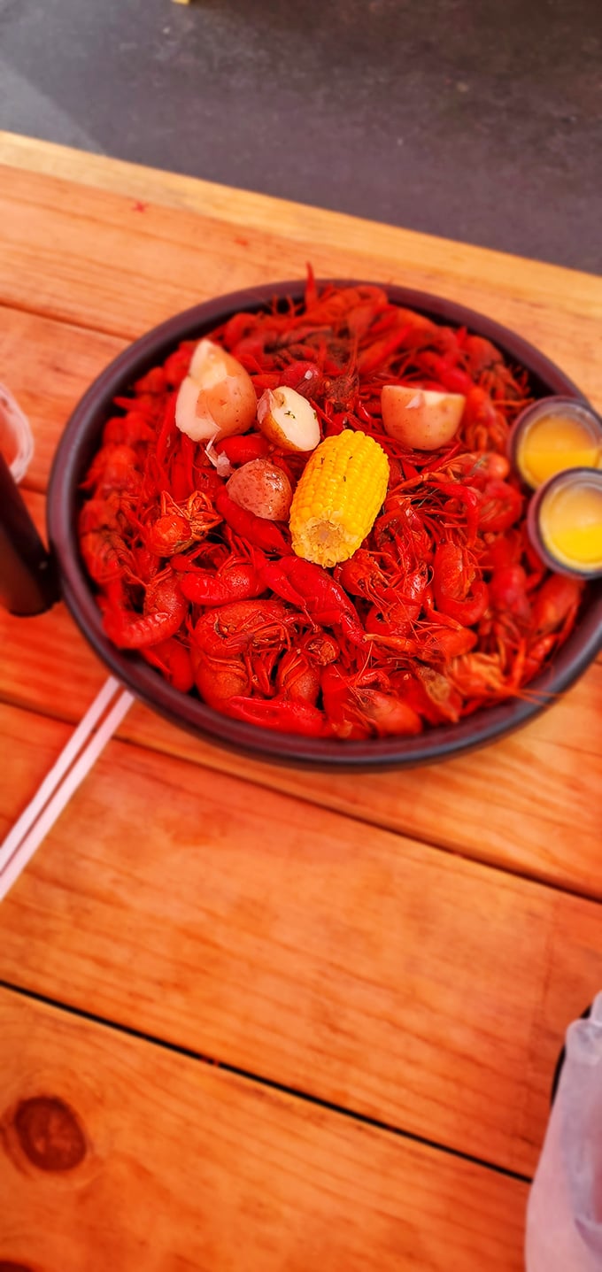 A crimson sea of crawfish that makes you want to dive right in. That corn cob island is just waiting for a butter bath.