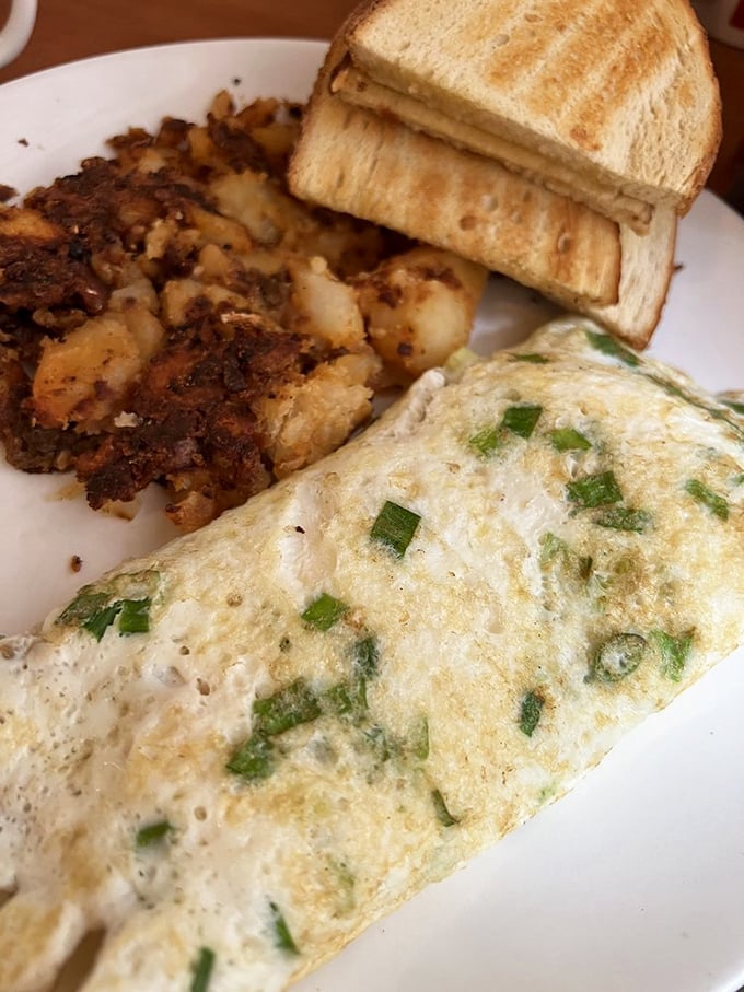 Fresh scallions dancing through cream cheese and eggs &ndash; proof that sometimes the simplest additions create the most memorable breakfast symphonies.