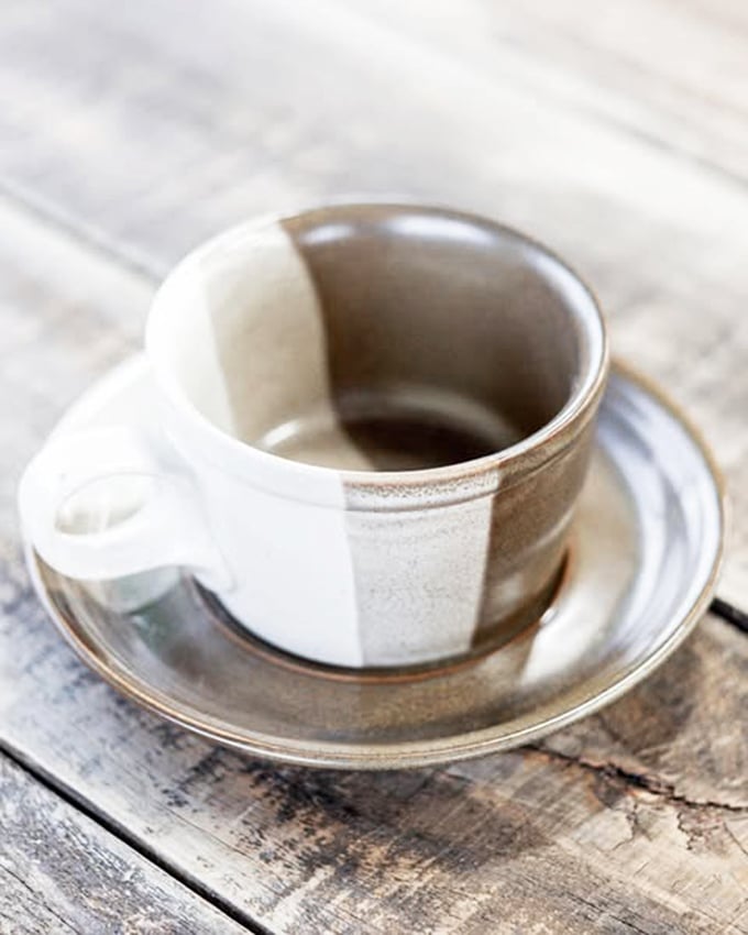 The two-tone ceramic mug that makes your morning coffee taste better somehow. Handcrafted character for pocket change&mdash;the antithesis of mass-produced sameness.