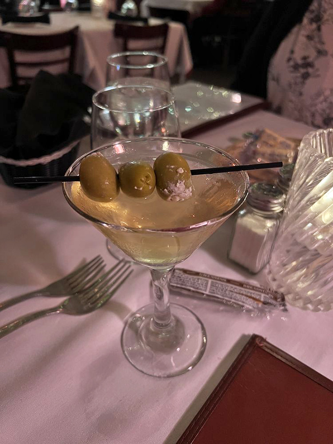 Three olives standing at attention in a perfectly chilled martini. The unofficial appetizer that makes waiting for your steak a pleasure, not a punishment.