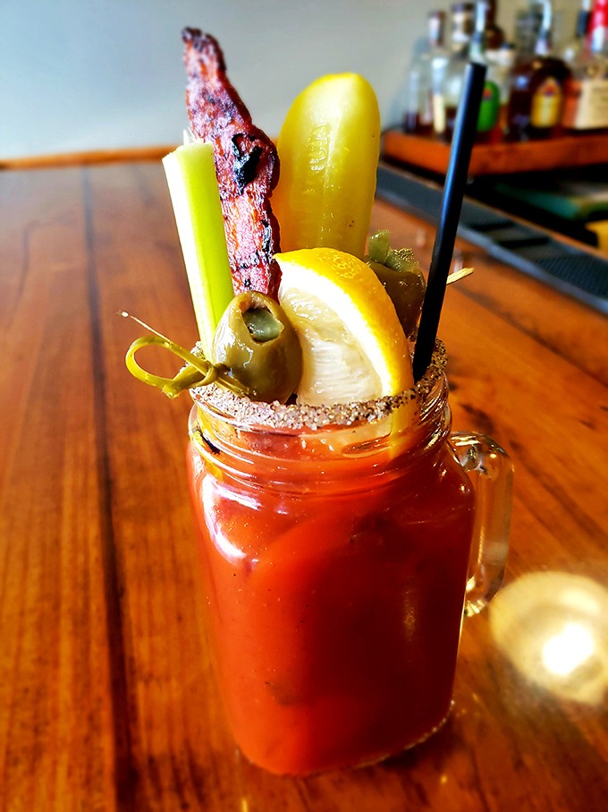 The Bloody Mary that eats like a meal! That strip of bacon isn't a garnish&mdash;it's a mission statement about this restaurant's dedication to excess.