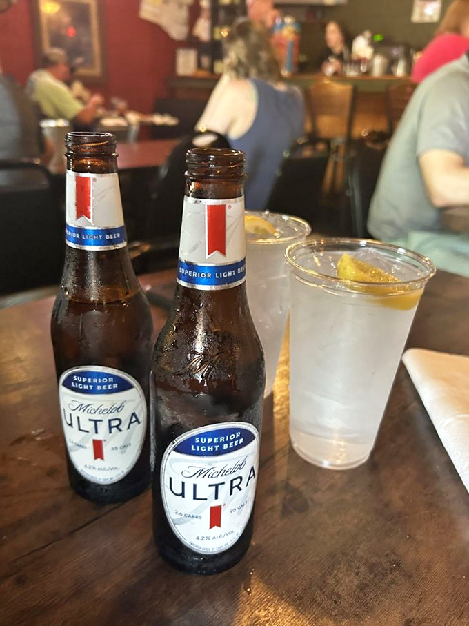 Cold Michelob Ultras and a sweating glass of something refreshing&mdash;because proper hydration while consuming legendary meat is just responsible adulting.