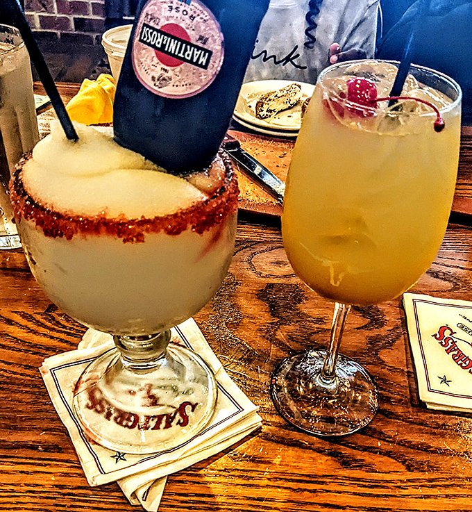 The margarita's salt rim and that golden cocktail beside it—liquid diplomats negotiating peace between your workweek and your weekend.
