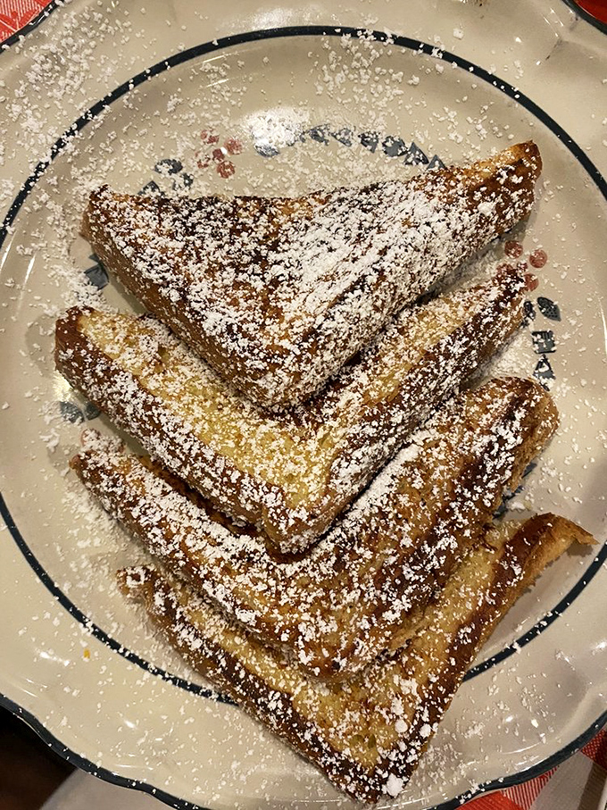 French toast triangles dusted with powdered sugar – the breakfast equivalent of putting on a tuxedo just to eat at home.
