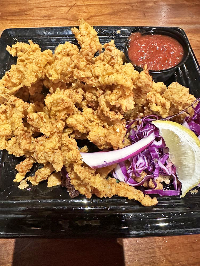 Golden-fried clams wearing their crunchy coating like formal attire, ready to dive into that spicy sauce at a moment's notice.