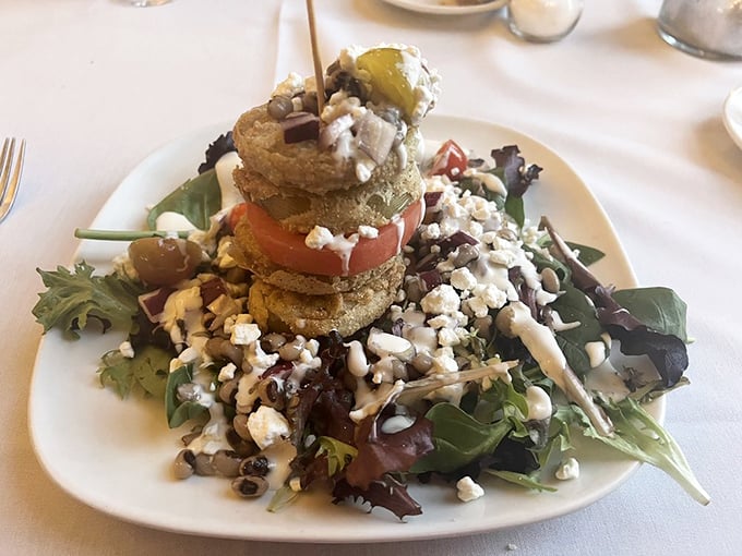 Architecture meets salad &ndash; fried green tomatoes stacked like Southern stonehenge, with mixed greens and feta creating a foundation worthy of applause.