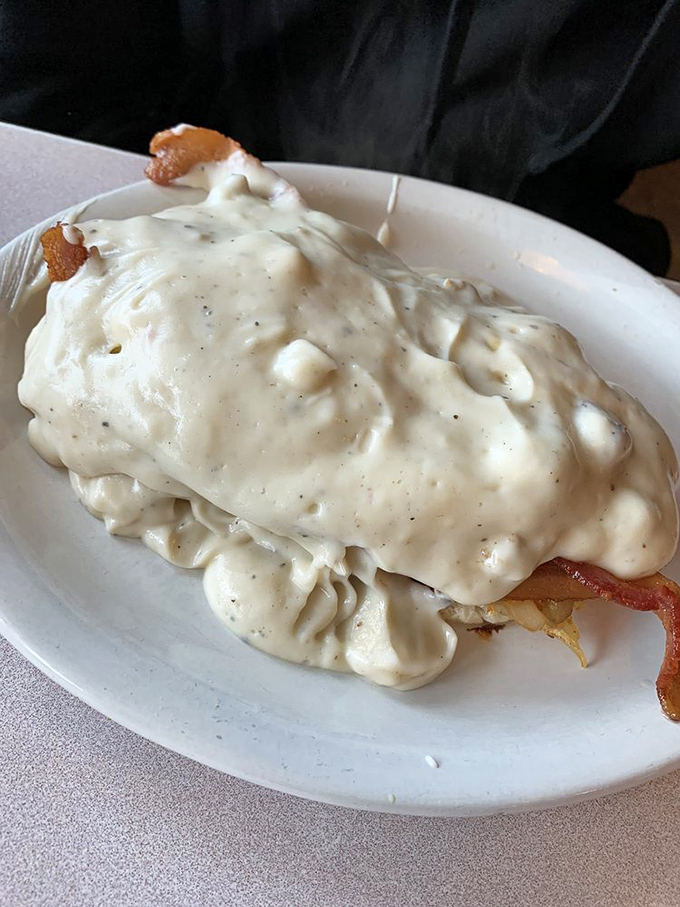 A breakfast so smothered in country gravy it could apply for witness protection. This plate doesn't just feed you&mdash;it hugs you from the inside.
