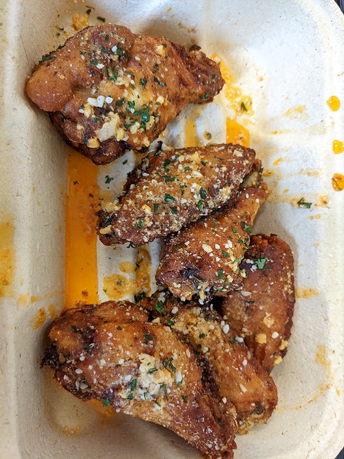 These wings aren't just cooked; they're transformed. Crispy, garlicky, and dusted with parmesan—finger-licking flavor worth every napkin.