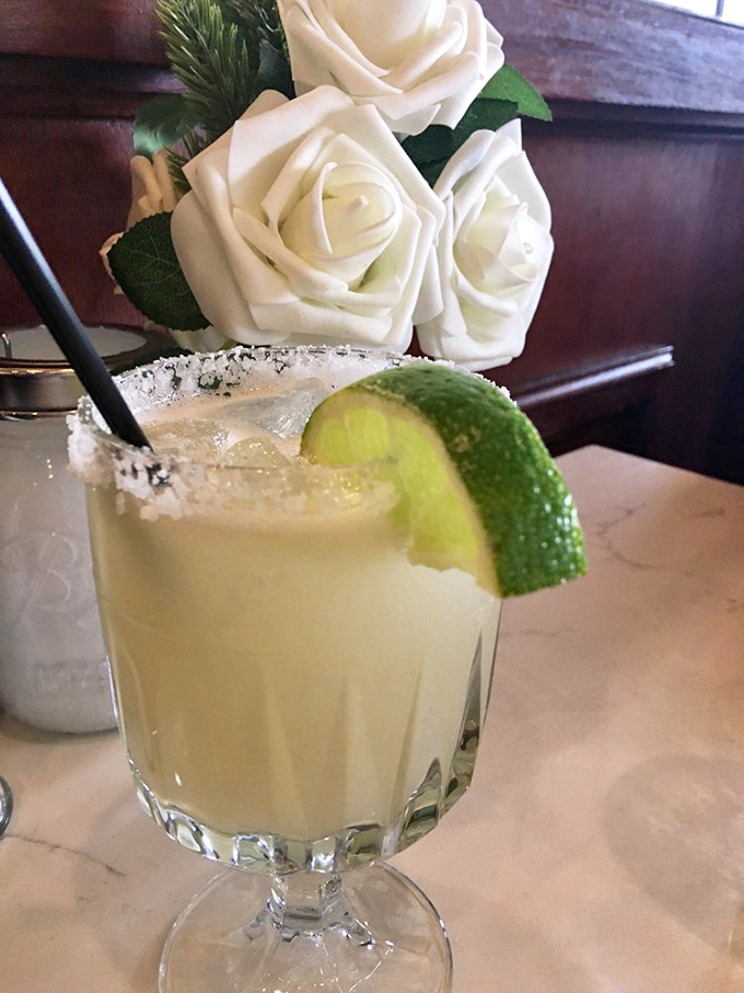 A margarita with a touch of class &ndash; salt-rimmed, lime-adorned, and served alongside elegant white roses. Cocktail hour never looked so sophisticated.