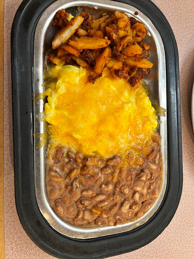 The holy trinity of New Mexican breakfast: beans, eggs, and chile, arranged on a plate like edible artwork.